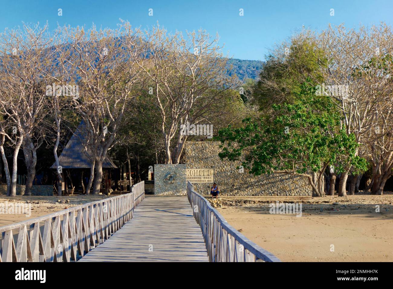 Footbridge with railing, entrance trees, building, Komodo National Park ...