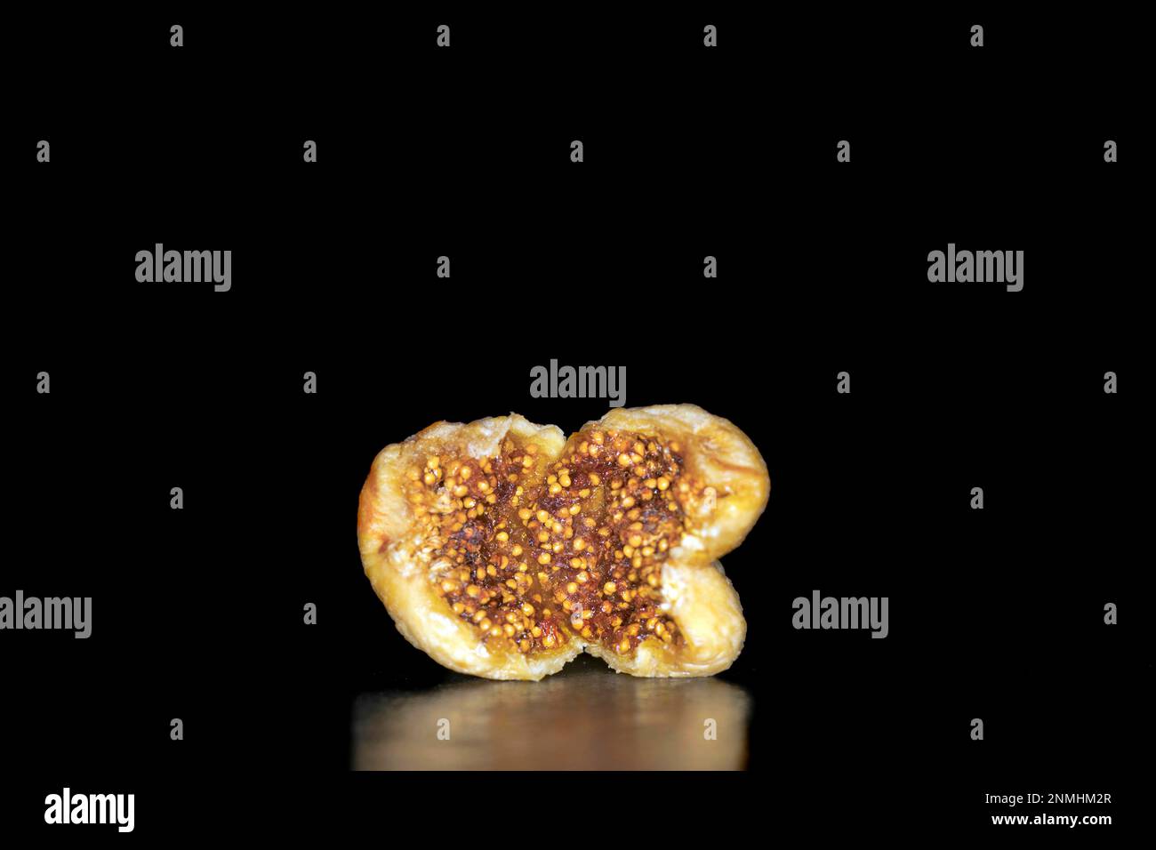 A ripped, dried common fig (Ficus carica), food photography with black ...