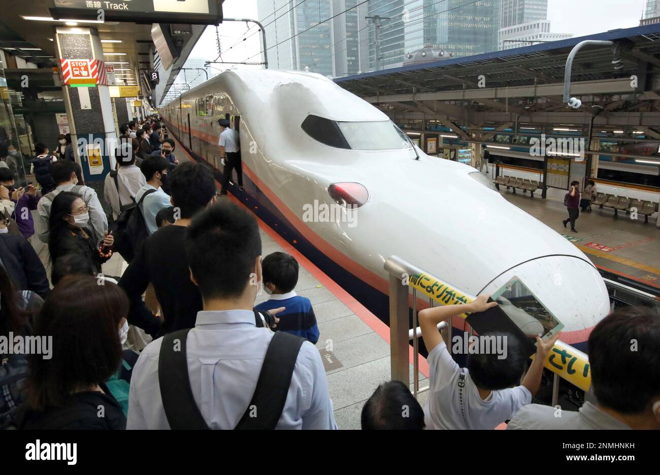 Many people take pictures of E4 Series Shinkansen bullet train at Tokyo Station in Tokyo on Oct ...