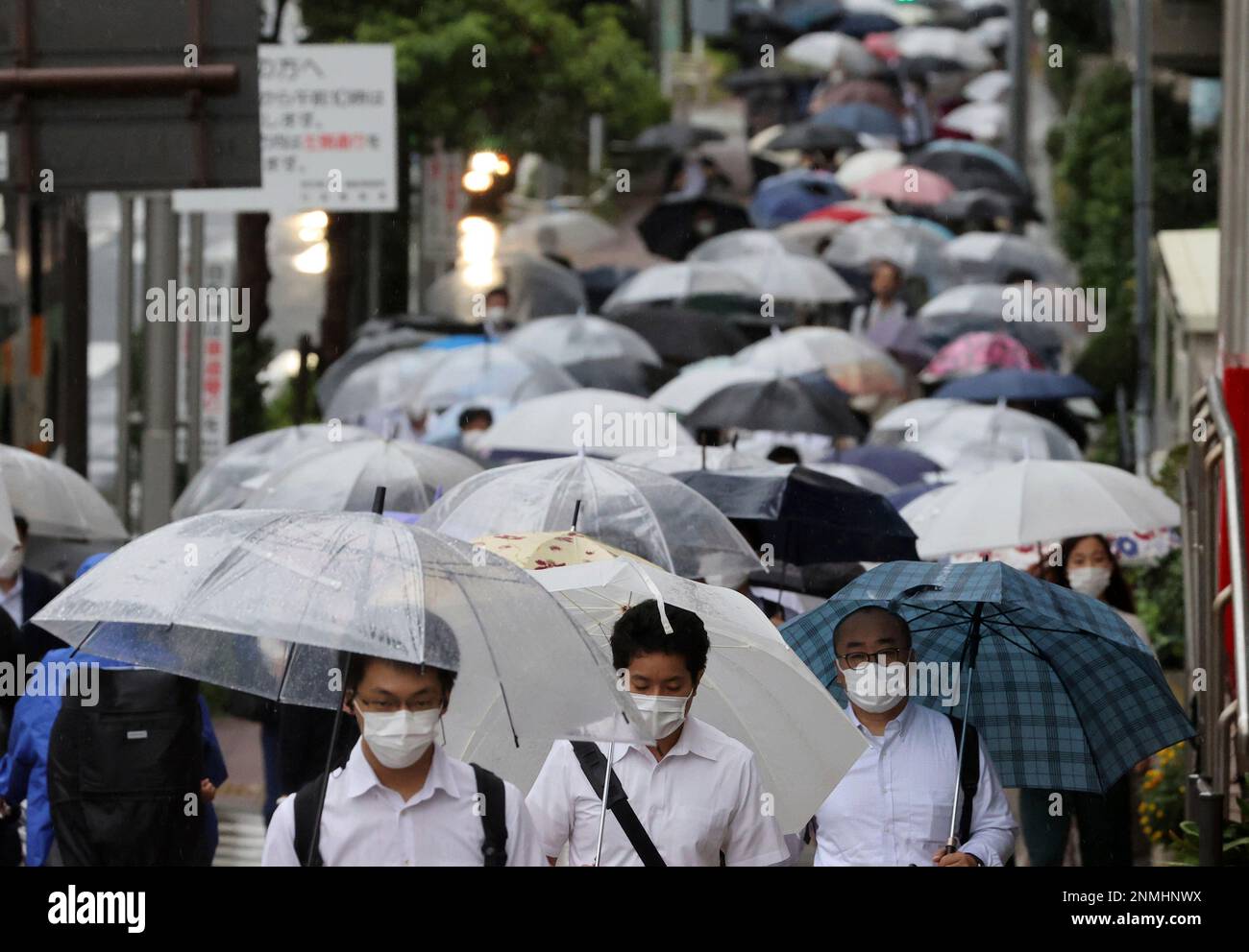 Commuters wearing masks walk in Tokyo on Oct. 1, 2021. The state of ...