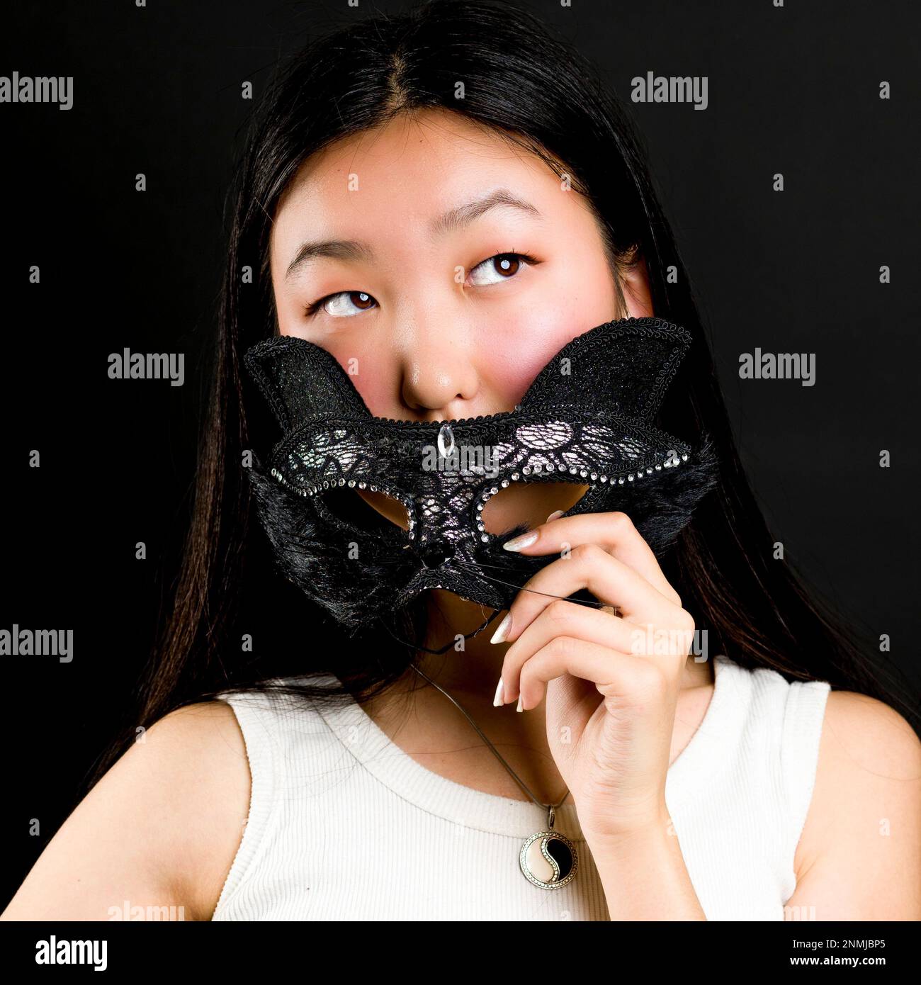 Close up of Teenage Asian Girl Taking Her Mask Off | Black Background ...