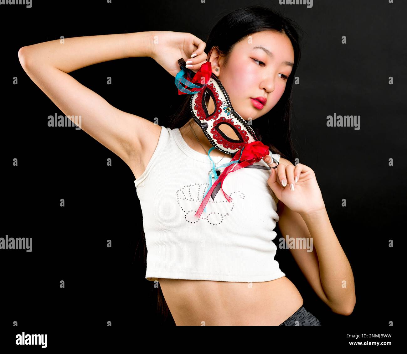 Close up of Teenage Asian Girl Taking Her Mask Off | Black Background ...
