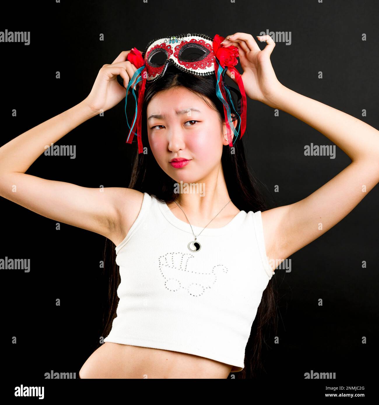 Close up of Teenage Asian Girl Taking Her Mask Off | Black Background ...