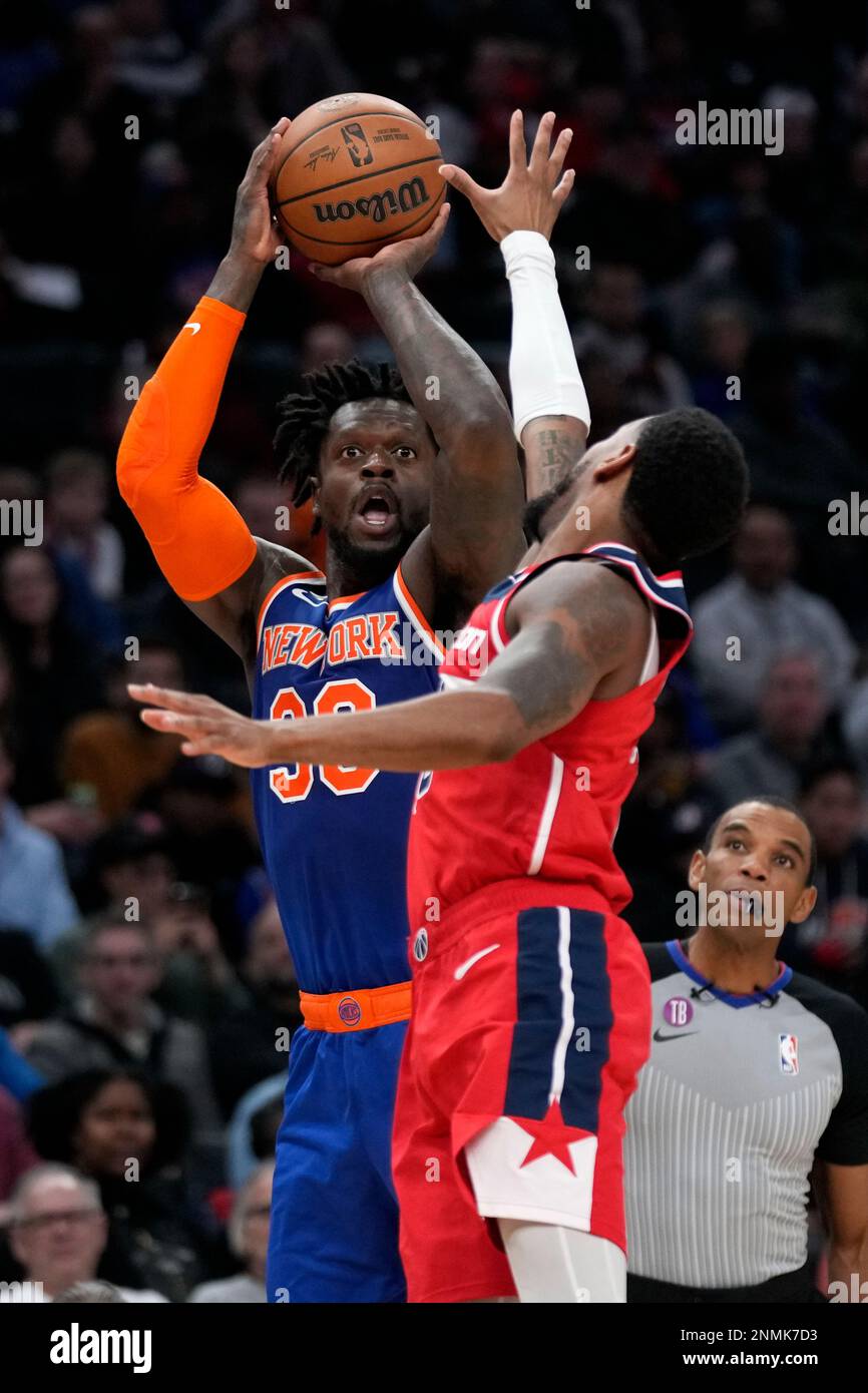 New York Knicks forward Julius Randle shoots over Washington Wizards guard Monte Morris in the ...