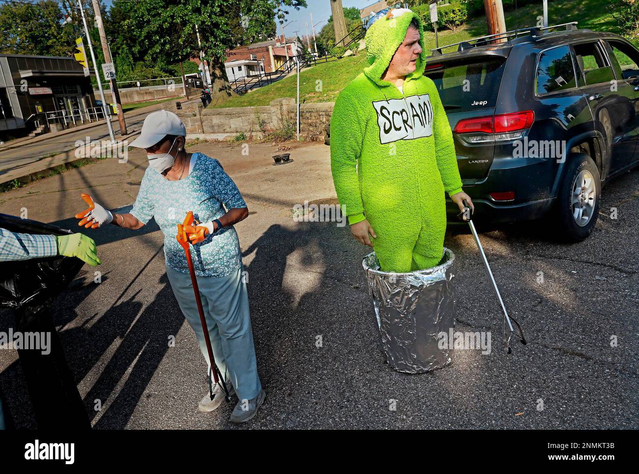 Manjula Germanwala gets ready to pick up litter next to organizer Ryan ...