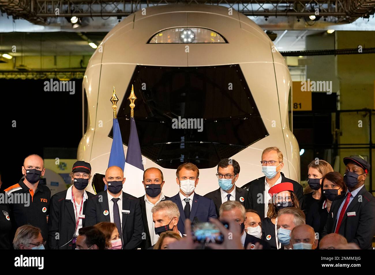 French President Emmanuel Macron, center, and other executives pose in ...