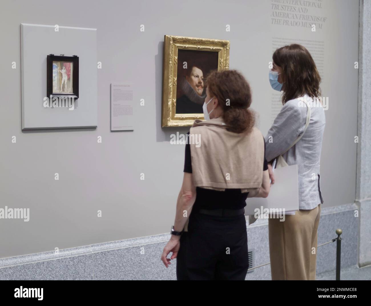 Two people look at several of the works that form part of the ...