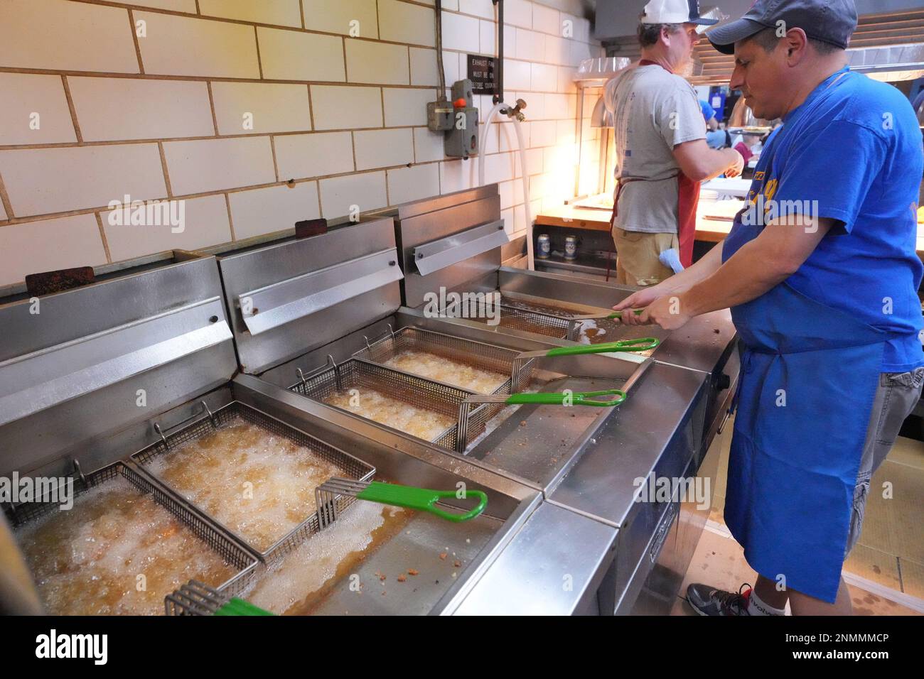St. Louis, United States. 24th Feb, 2023. Cooks watch the frying cod at ...