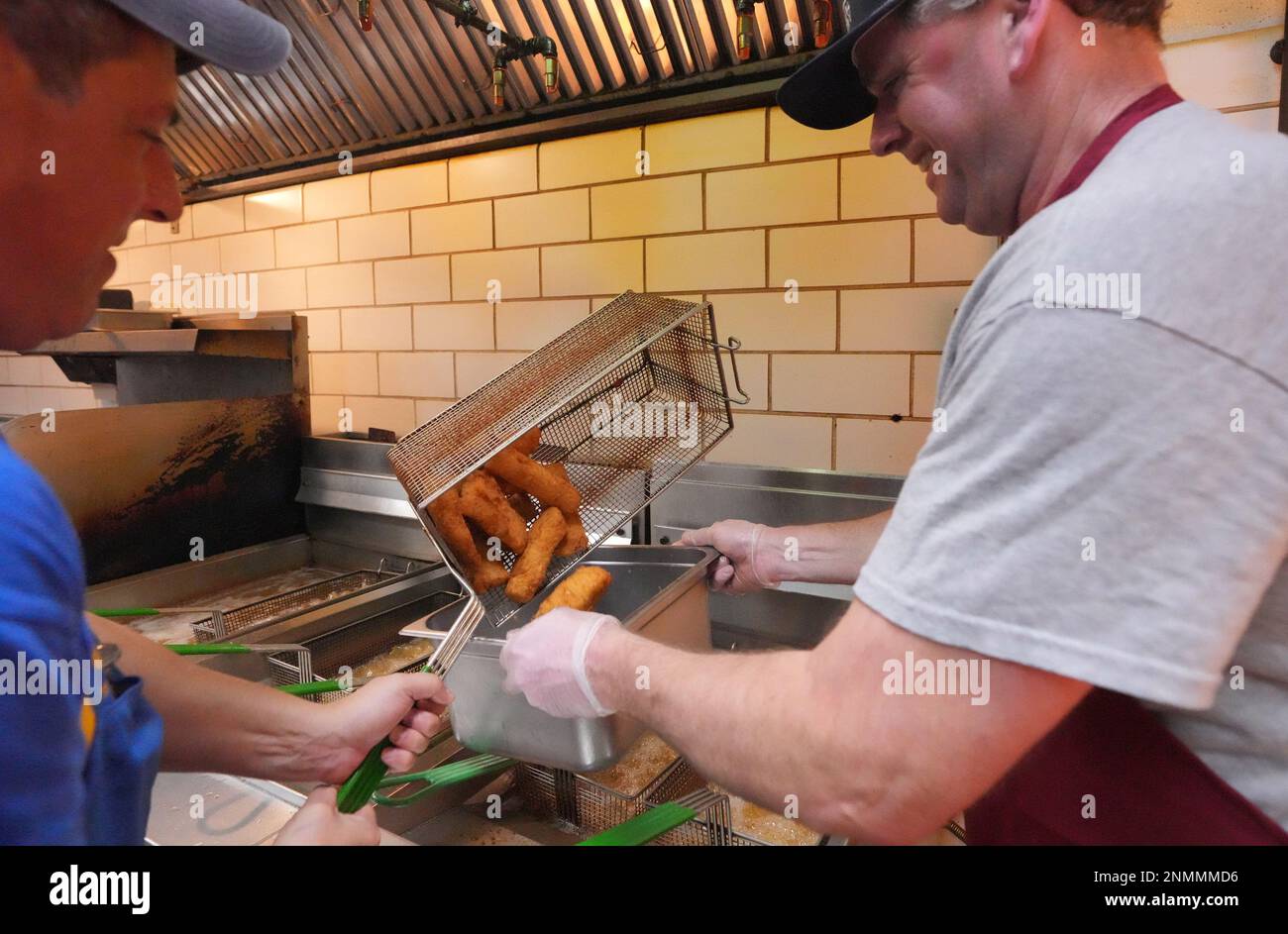 St. Louis, United States. 24th Feb, 2023. Cooks remove cod fish from ...