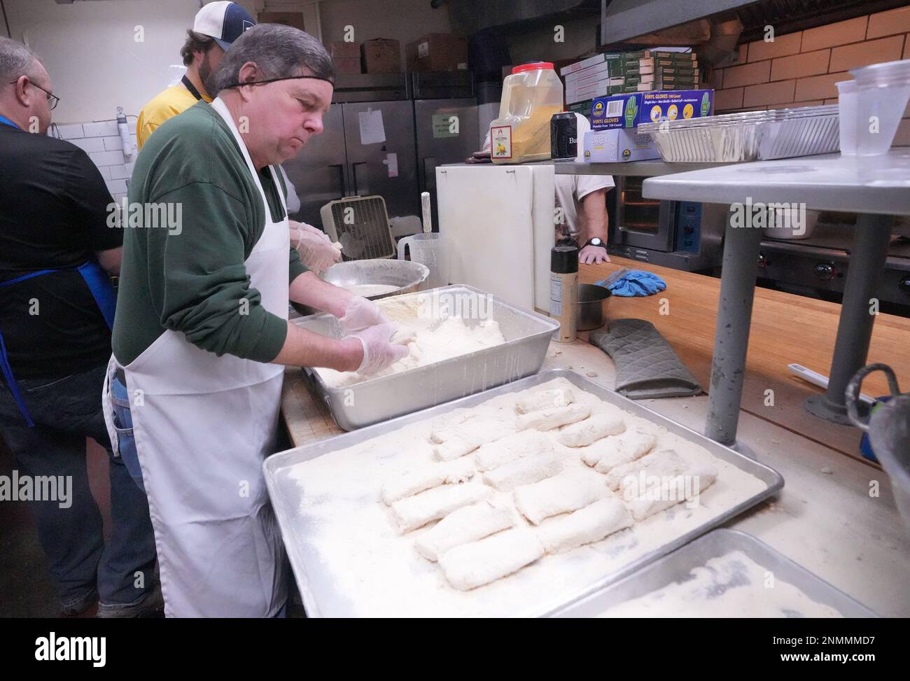 St. Louis, United States. 24th Feb, 2023. Cook Mark Camp breads cod ...