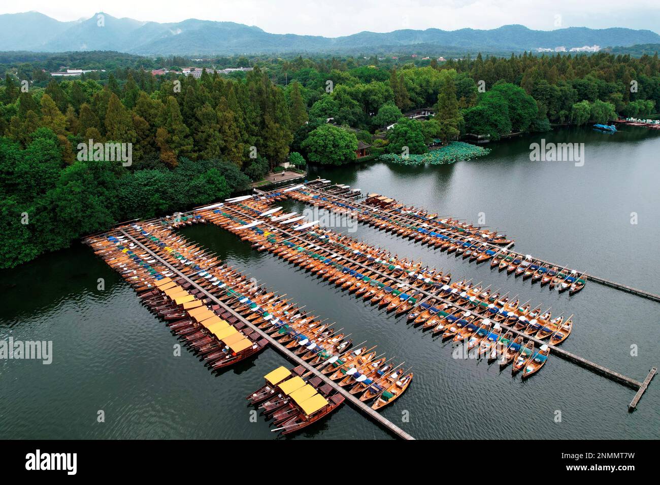 An aerial view of the tourist boats secured to a pier in the West Lake ...