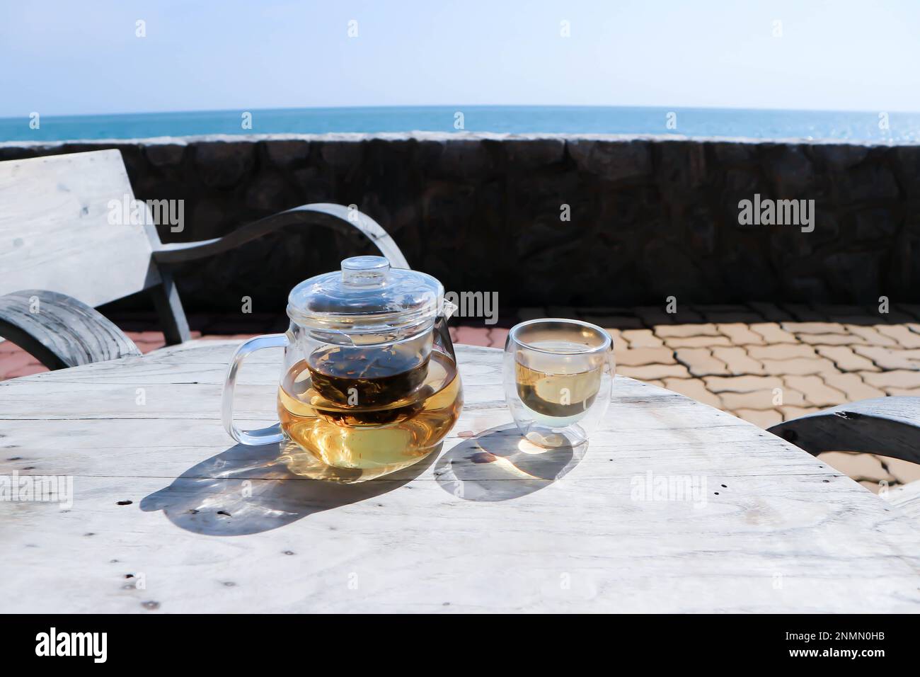 tea and teapot near the beach , sea and sky background Stock Photo - Alamy