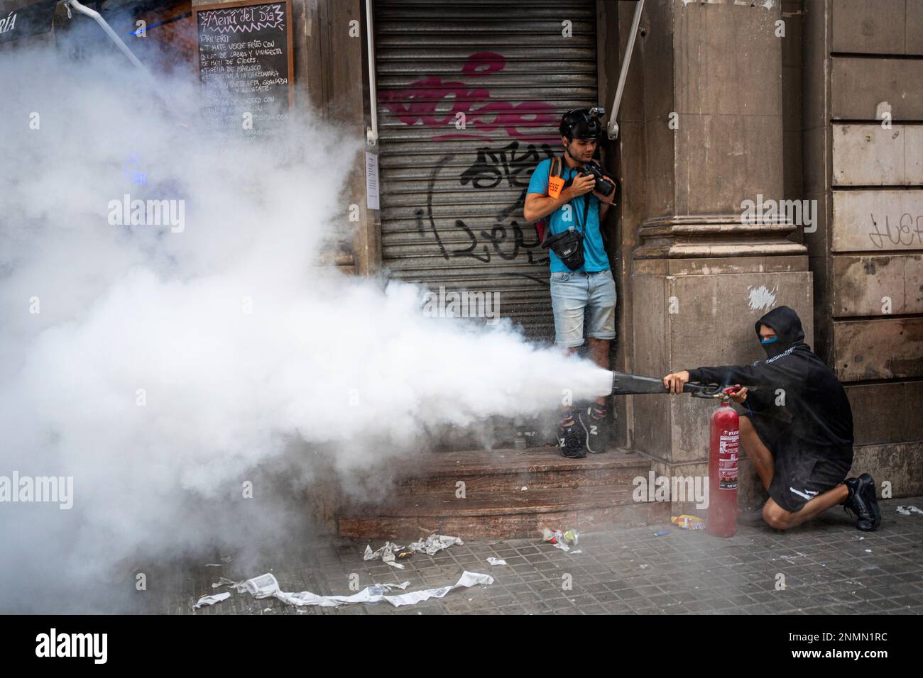 A man sprays the police with a fire extinguisher during the ...