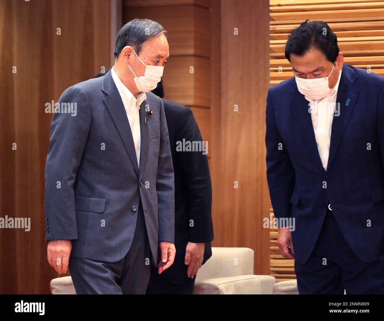 Japanese Prime Minister Yoshihide Suga (L) attends a cabinet meeting at ...
