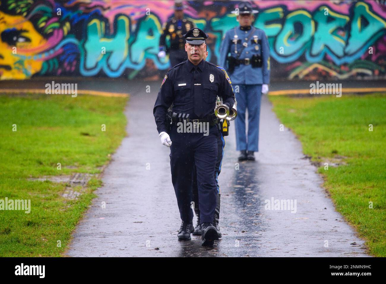 A taps detail processes through Xfinity Theatre during funeral services ...