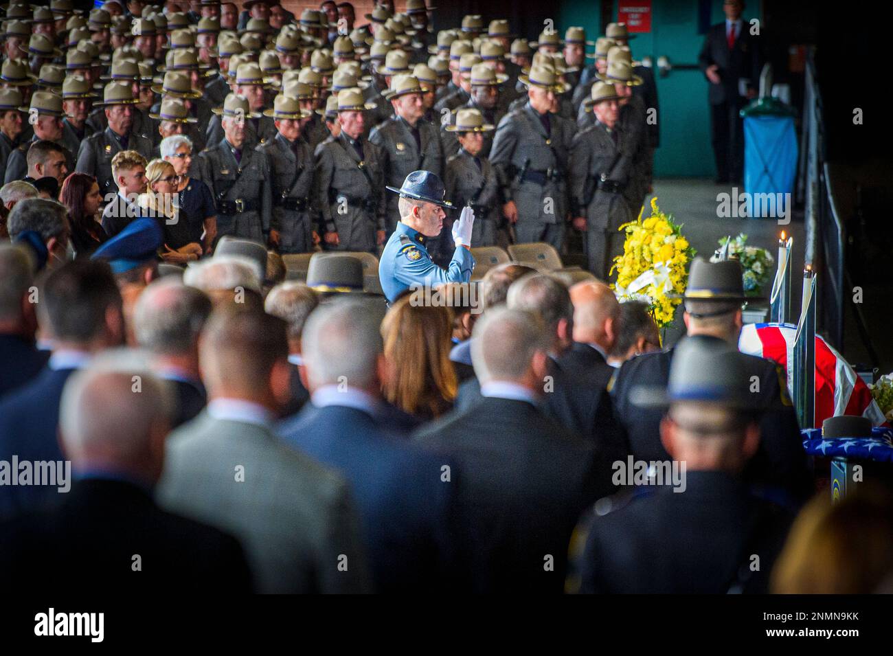 A Maine State Trooper salutes the casket of Connecticut State Police ...