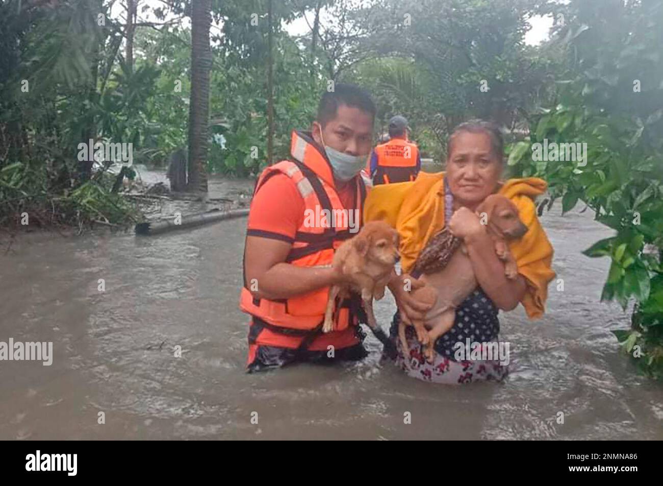 In this handout photo provided by the Philippine Coast Guard, a rescuer ...