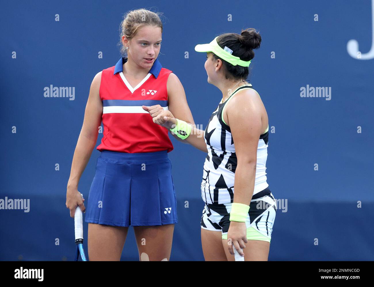 Matilda Mutavdzic and Julia Garcia talk between points during a Junior ...