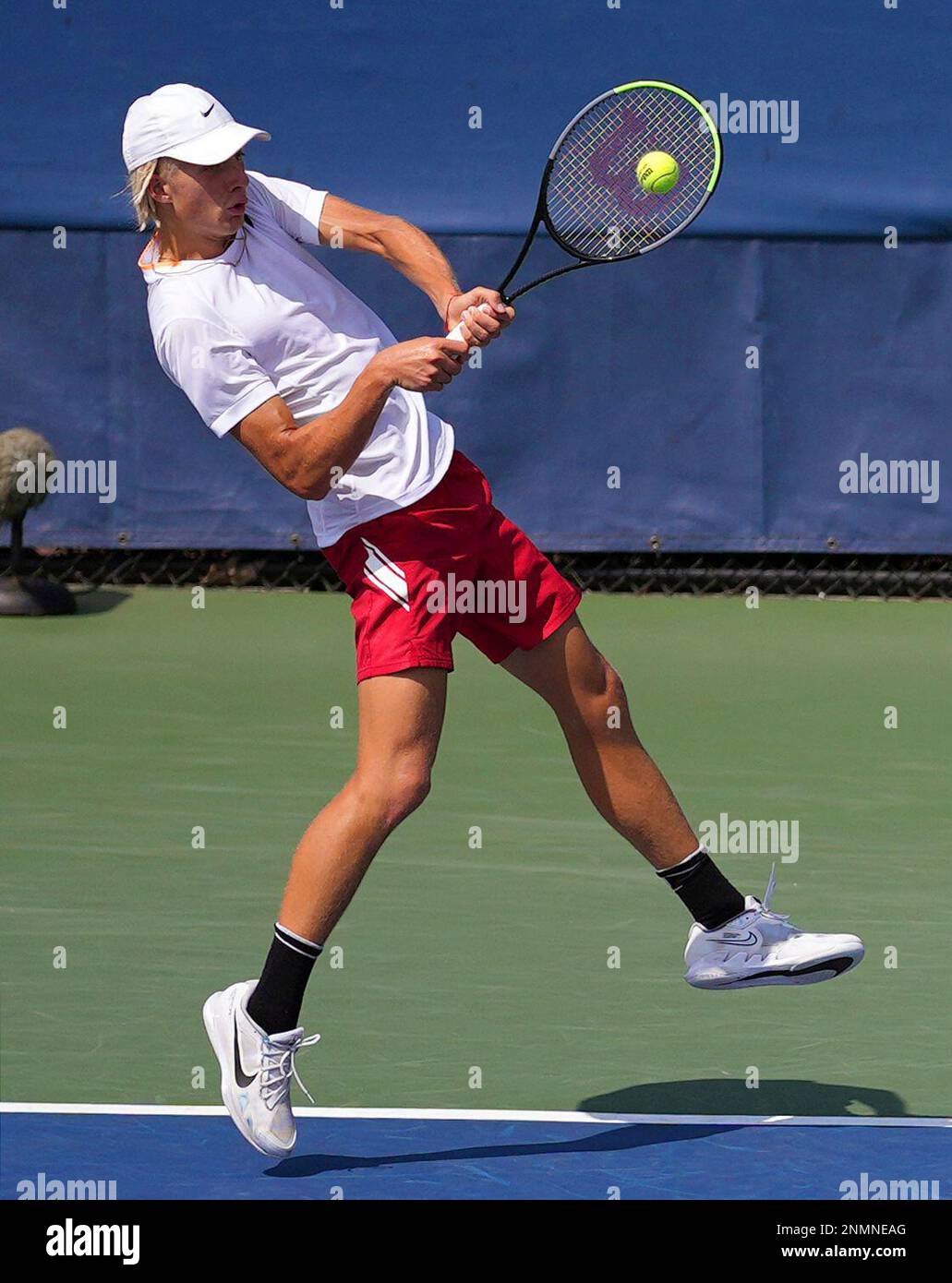 Mark Lajal returns a shot during a Junior Boys' Singles match at the ...