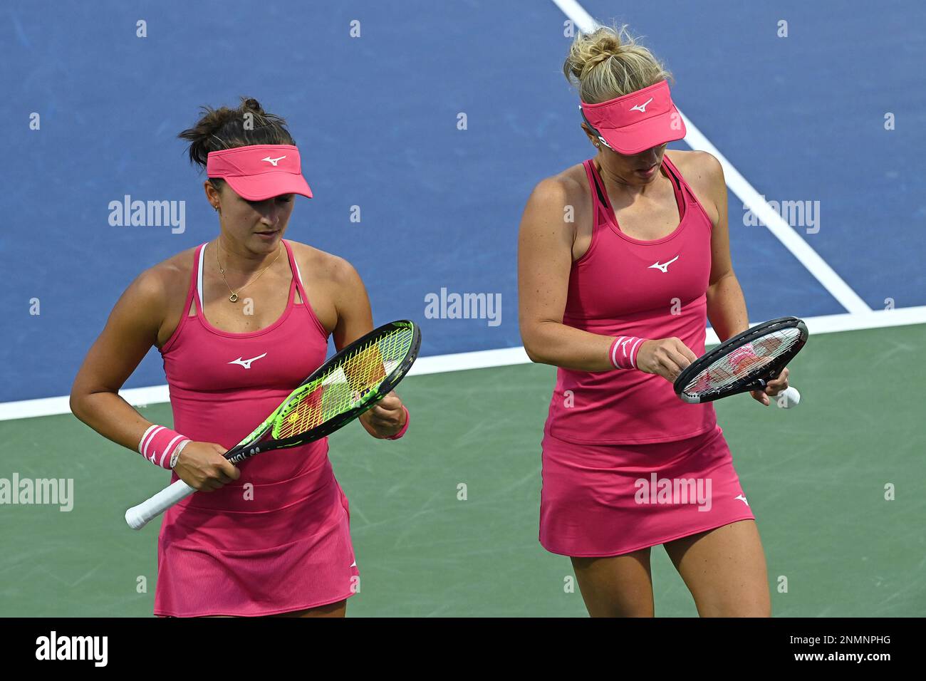 Anastasia Rodionova and Arina Rodionova fix their rackets during a ...