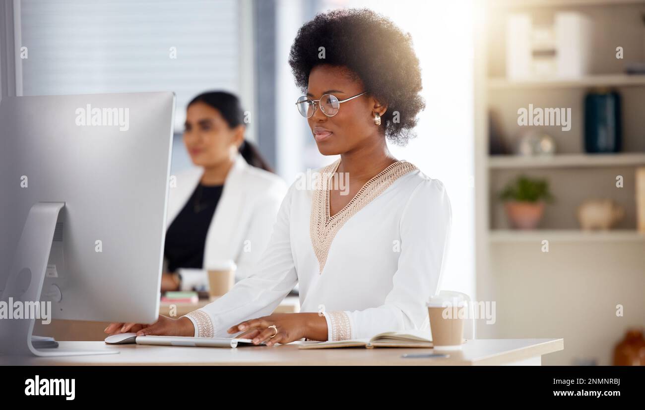 Serious black woman, computer and working in focus checking corporate ...