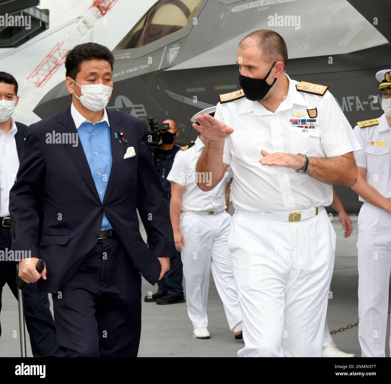 Japanese Defense Minister Nobuo Kishi is ushered by British Royal Navy ...