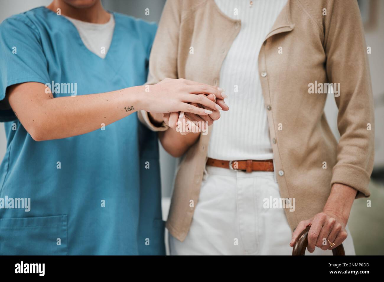 Walking stick, senior woman and nurse holding hands for disability ...