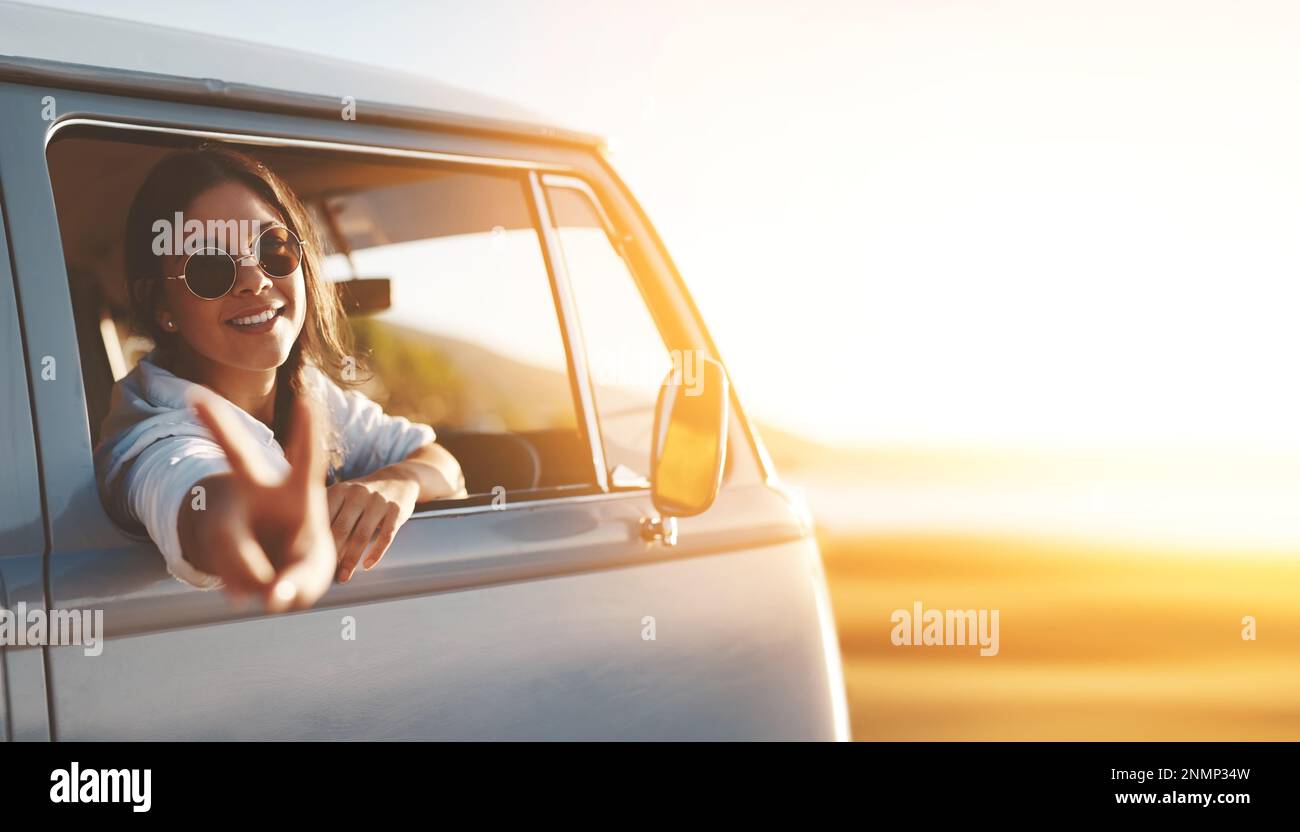 Next stop, everywhere and anywhere. a young woman leaning out of a vans ...