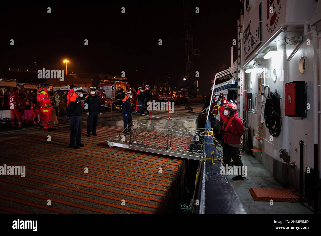 Ortona, Italy. 25th Feb, 2023. Guardia Costiera officers wait outside ...