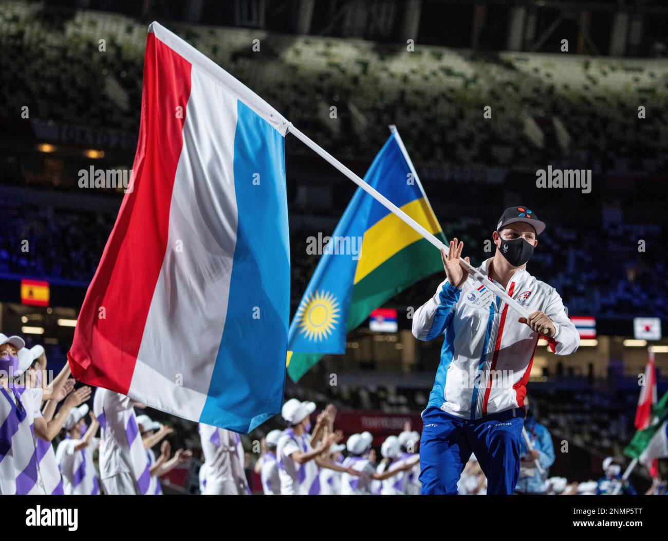 Flag Bearer Tom Habscheid of Luxembourg carries the national flag into ...