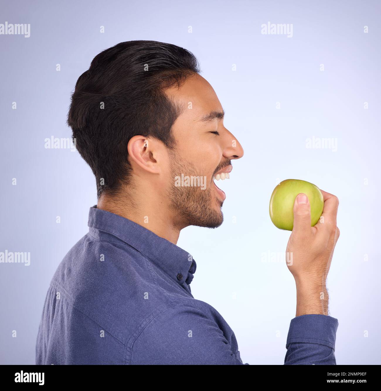 Man, face and profile, eating apple with nutrition, food and health ...