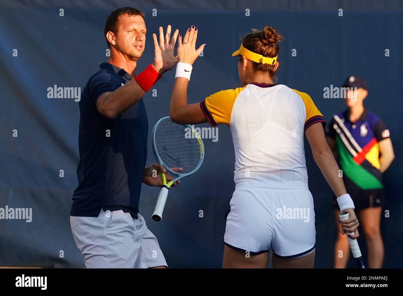 Filip Polasek high fives Belinda Bencic during a Mixed Doubles match at ...