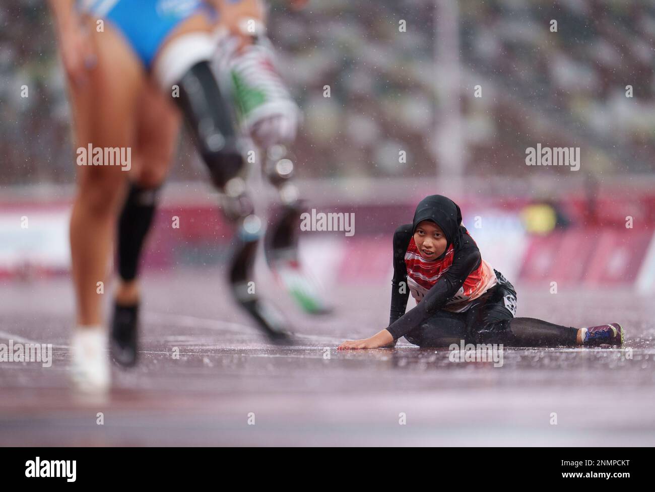Karisma Evi Tiarani INA falls over the finish line after the Athletics ...