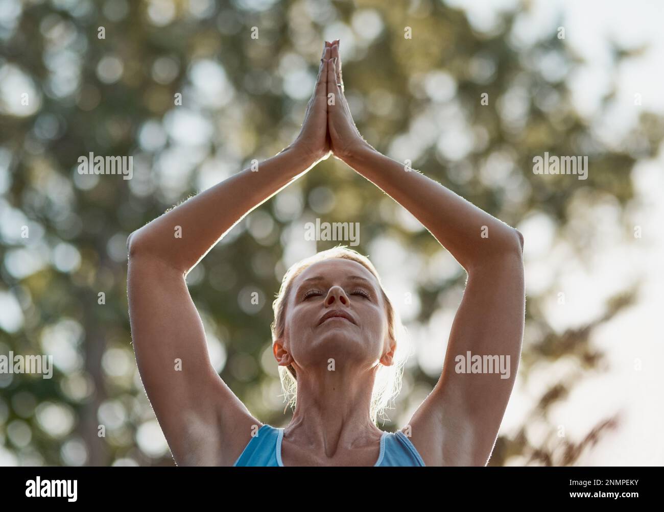 Give thanks to the universe. mature and fit woman engaging in a ...