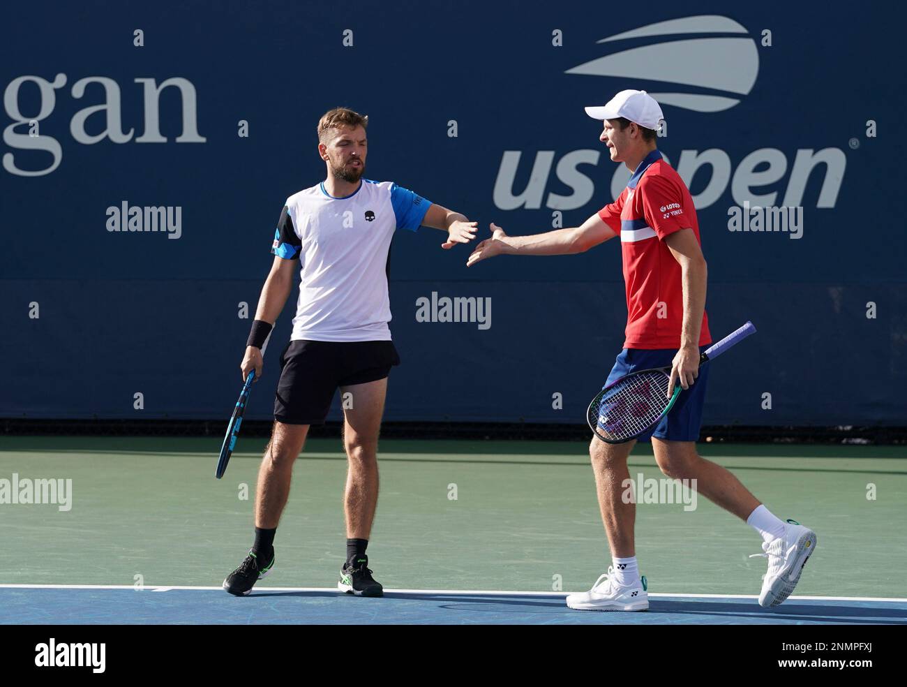 Szymon Walkow and Hubert Hurkacz high five during a Men's Doubles match ...