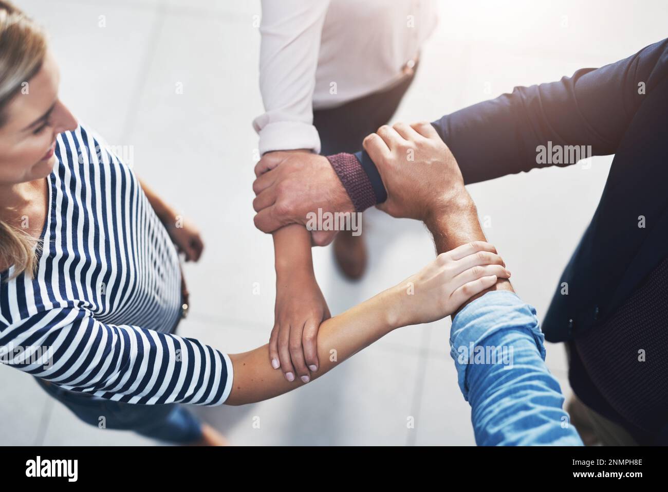 Linking in for success. High angle shot of a group of unrecognizable ...