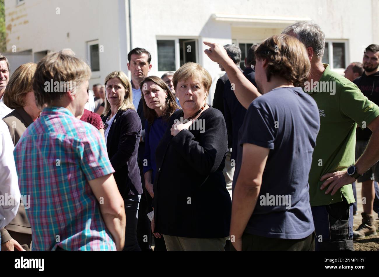 German Chancellor Angela Merkel talk to residents during her visit ...