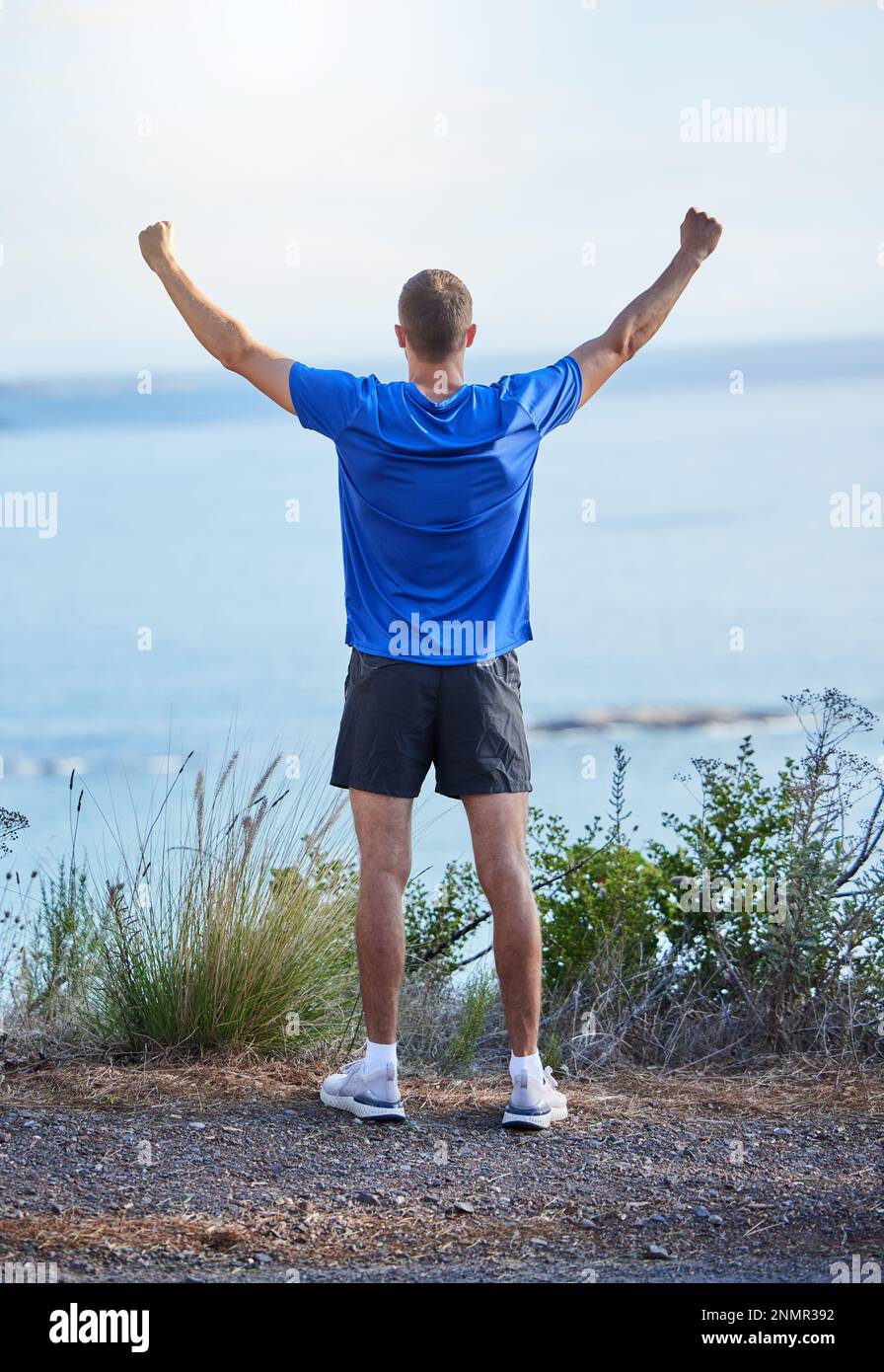Success, freedom and running with back of man in nature for health ...