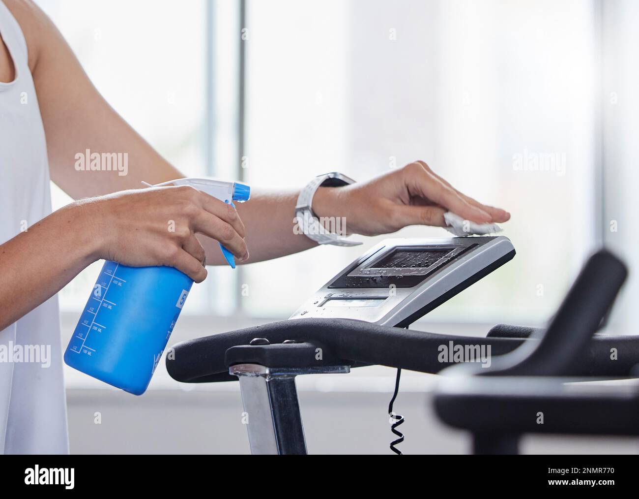 Sanitizer, disinfect and fitness person cleaning gym surface before ...