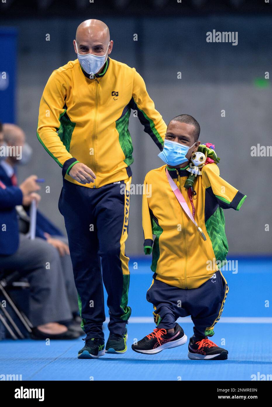 Gold medalist Gabriel Geraldo Dos Santos Araujo of Brazil walks with his coach after the men's ...