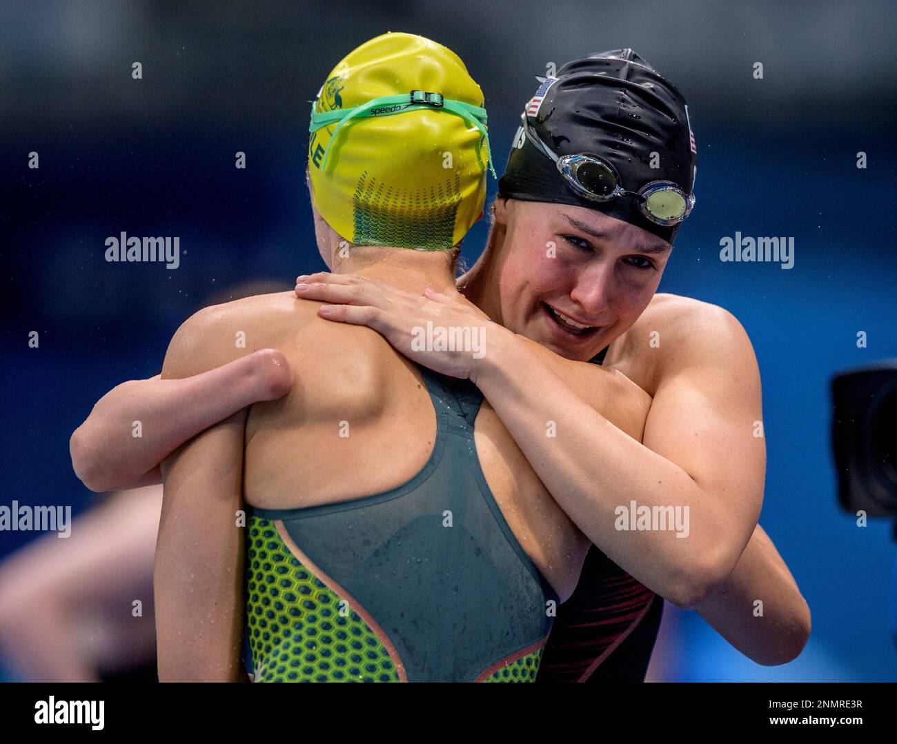 Natalie Sims of the U.S. hugs a member of Team Australia at the end of ...