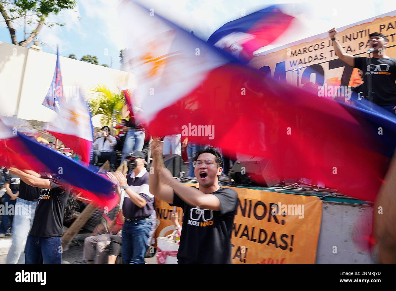 Protesters wave Philippine flags during a rally to observe the 37th ...