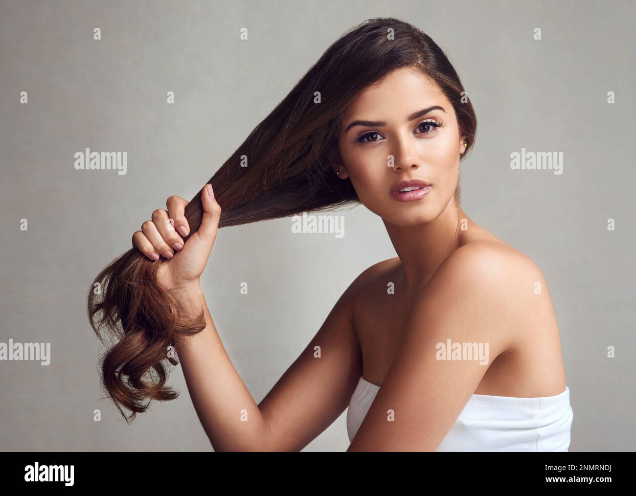 The longer the hair, the more they stare. Studio shot of a young ...