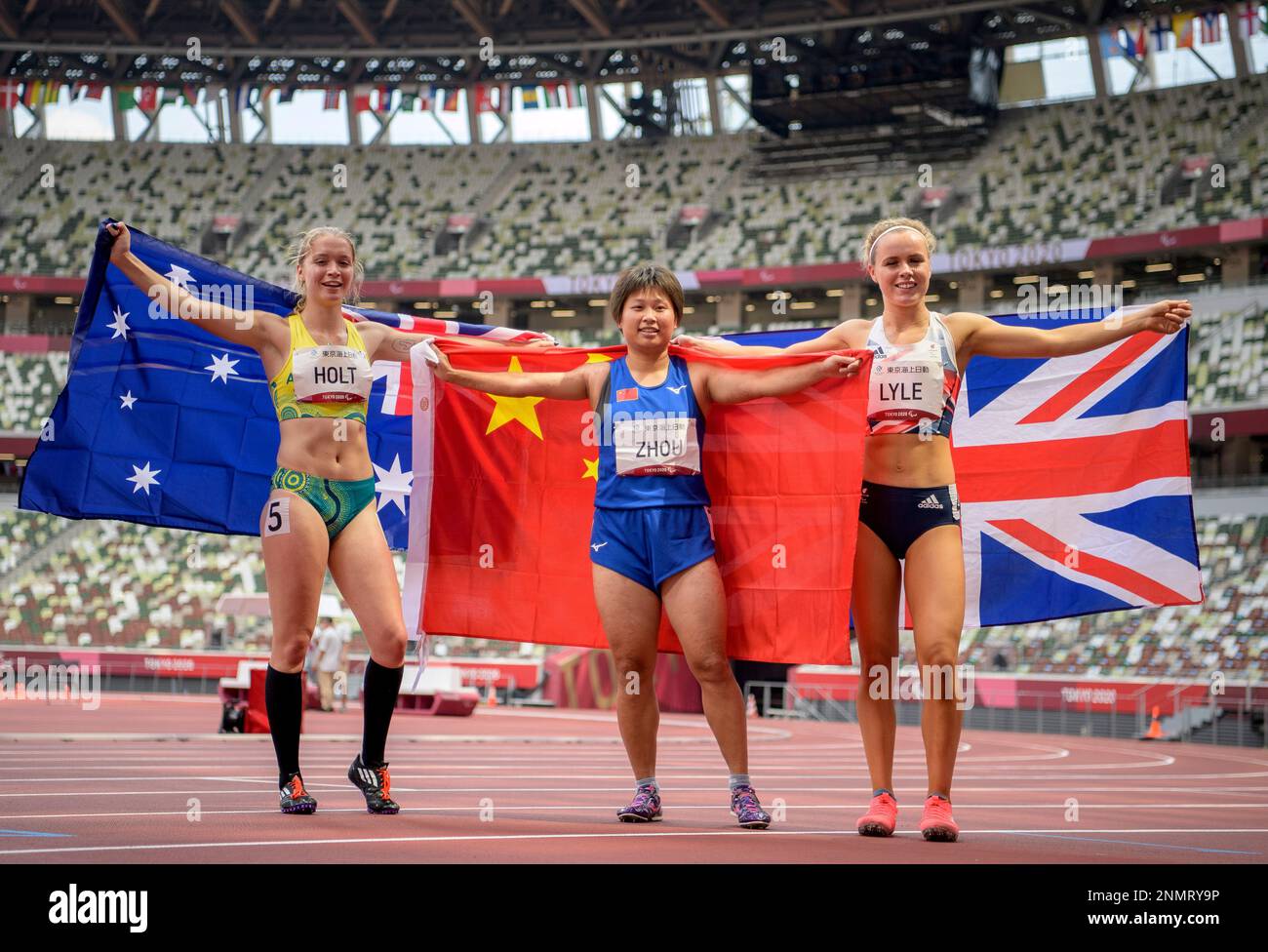 Winner Zhou Xia Zhou, of China, is joined by second-place Isis Holt, of Australia, and third ...