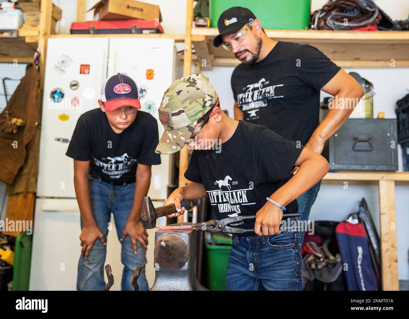 Sergio Rangel, right, and his son Easton, 10, watch Declan Rangel, 6 ...