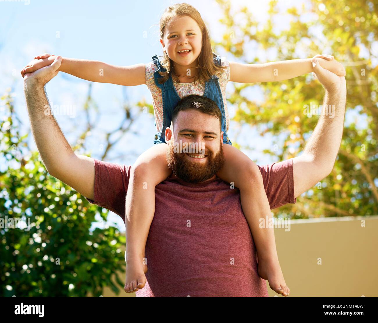 Dads shoulders have the best view. an adorable little girl sitting on ...