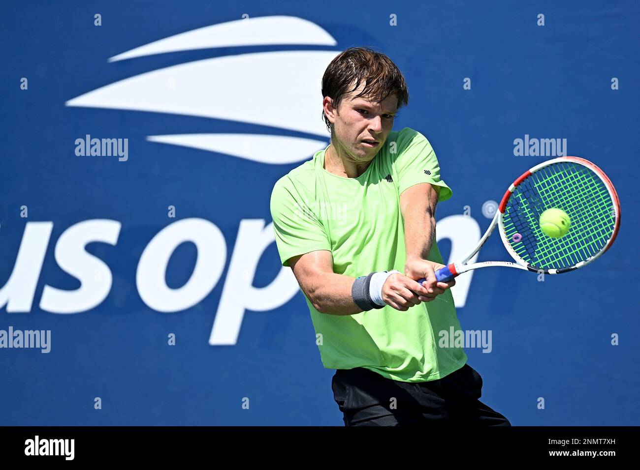 Stefan Kozlov returns a shot during qualifying at the 2021 US Open ...