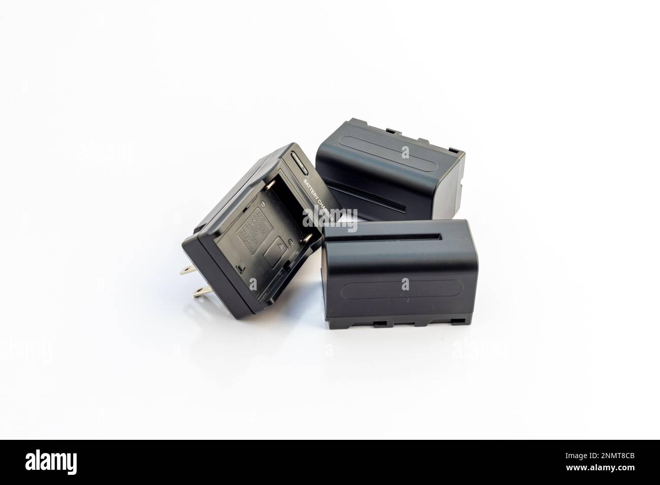 Rechargeable batteries with charger isolated on white background Stock ...