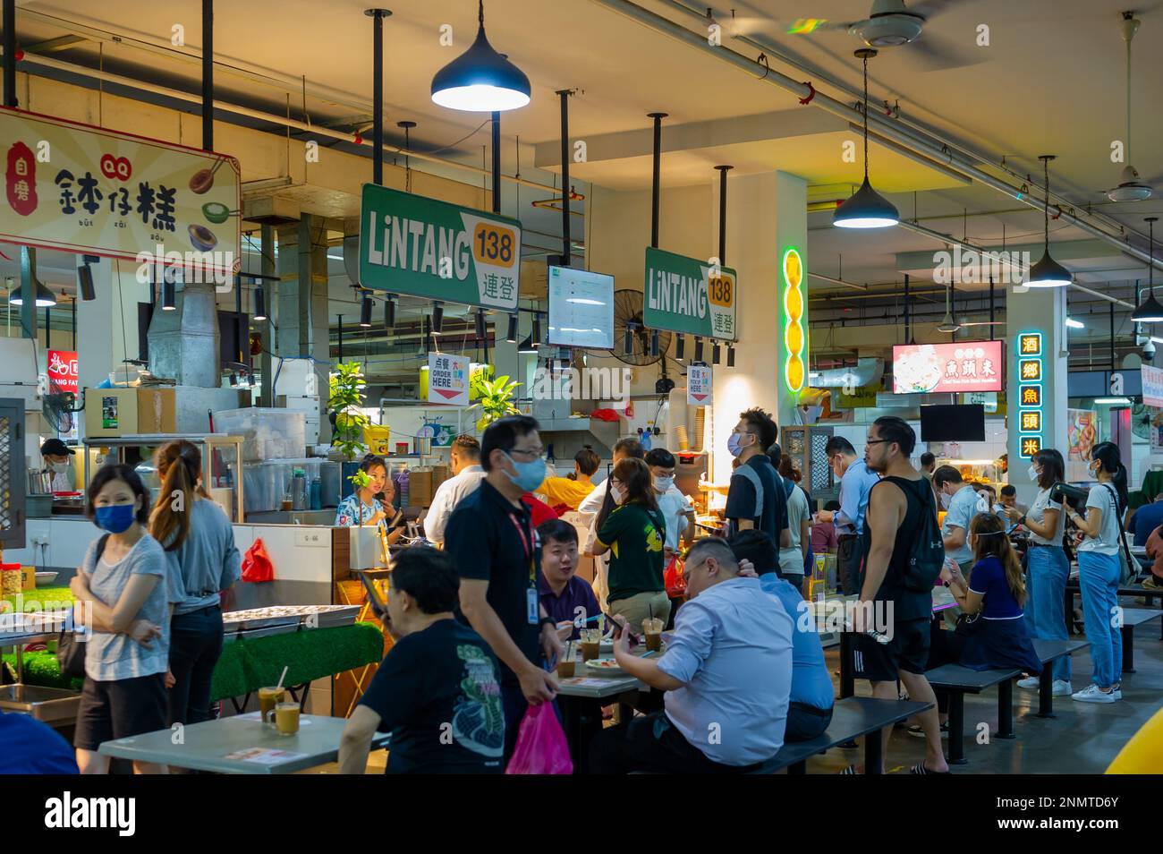 Chinese food vendors with customers eating at the ICC Pudu Food Court ...