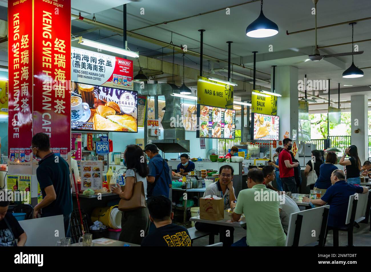 Chinese food vendors with customers eating at the ICC Pudu Food Court ...